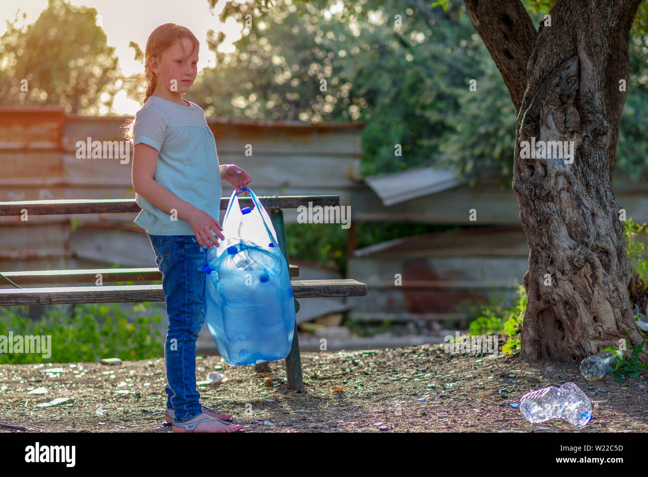 Child picking garbage hi-res stock photography and images - Alamy