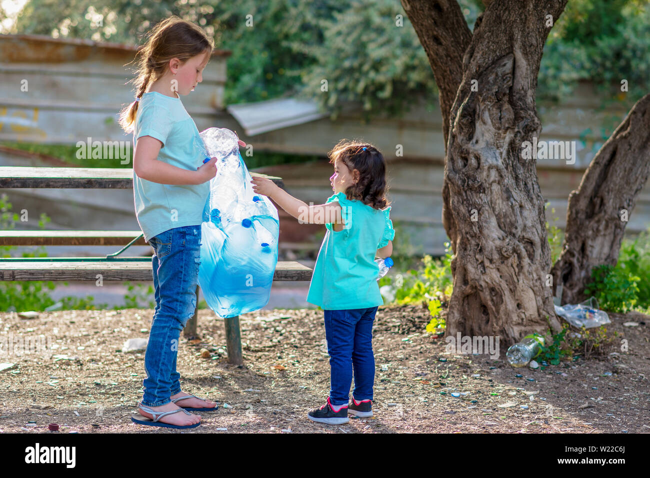 Two kids volunteer charity environment.Children with garbage bags ...