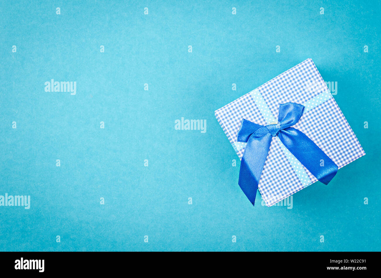 Blue background with presents and ribbons and copy space for your text ...