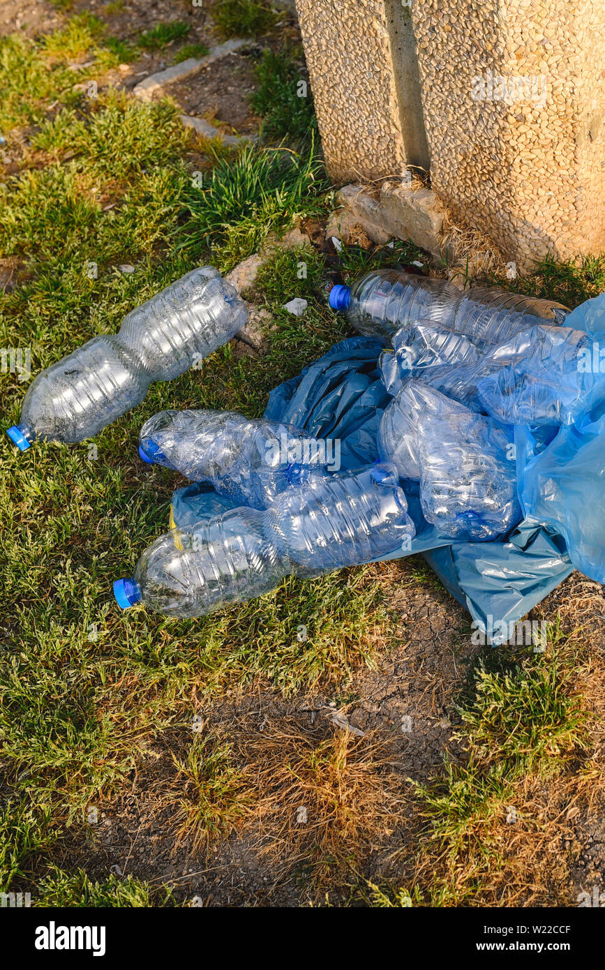Plastic bottles and bags on the grass. Plastic Waste In The Nature ...