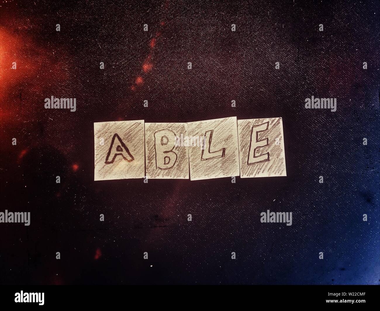 on the dark black background the word able on he paper Stock Photo - Alamy
