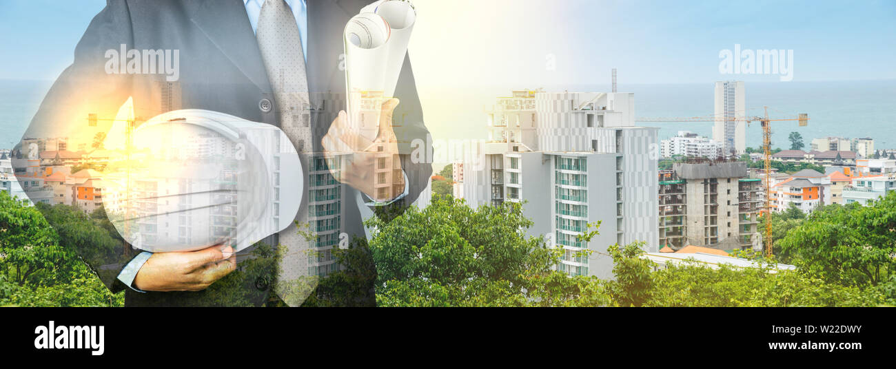 Double exposure of Engineer with safety helmet on construction industry ...
