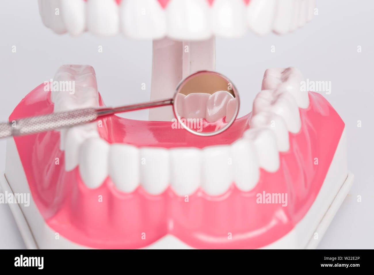 White teeth and dental instruments on white background Stock Photo - Alamy