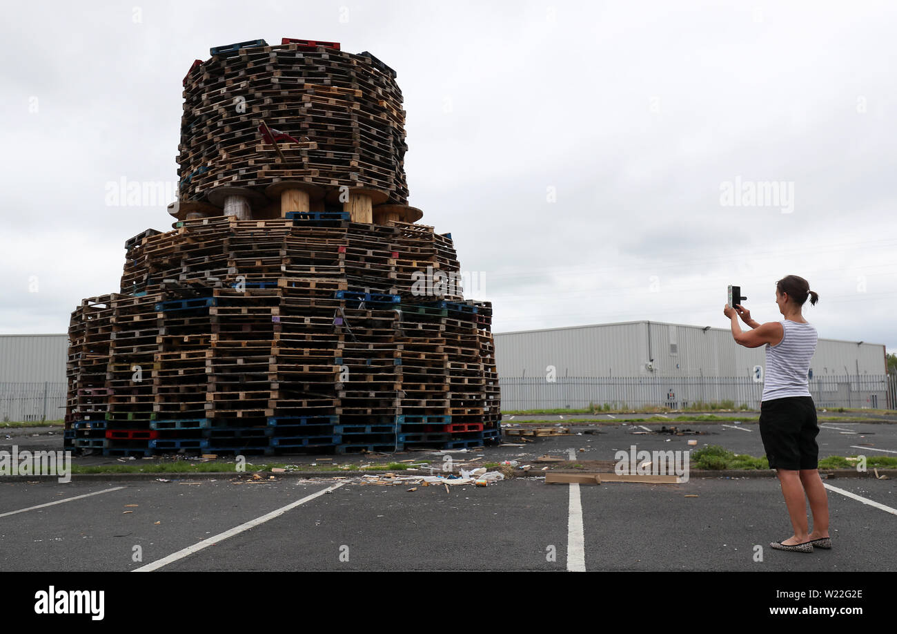 A woman takes a photograph of one of the contentious bonfires which is ...