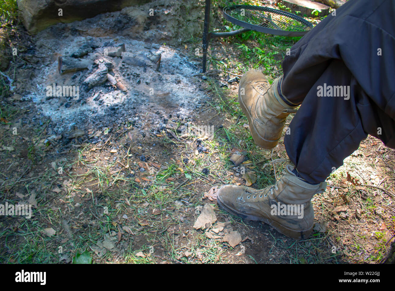 man sitting next to last nights barbecue ashes Stock Photo - Alamy