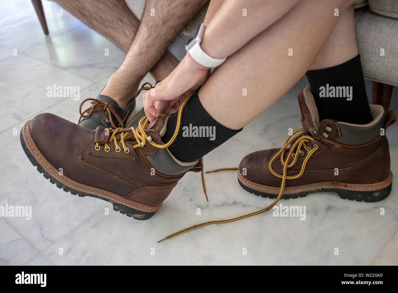 Putting on boots hi-res stock photography and images - Alamy
