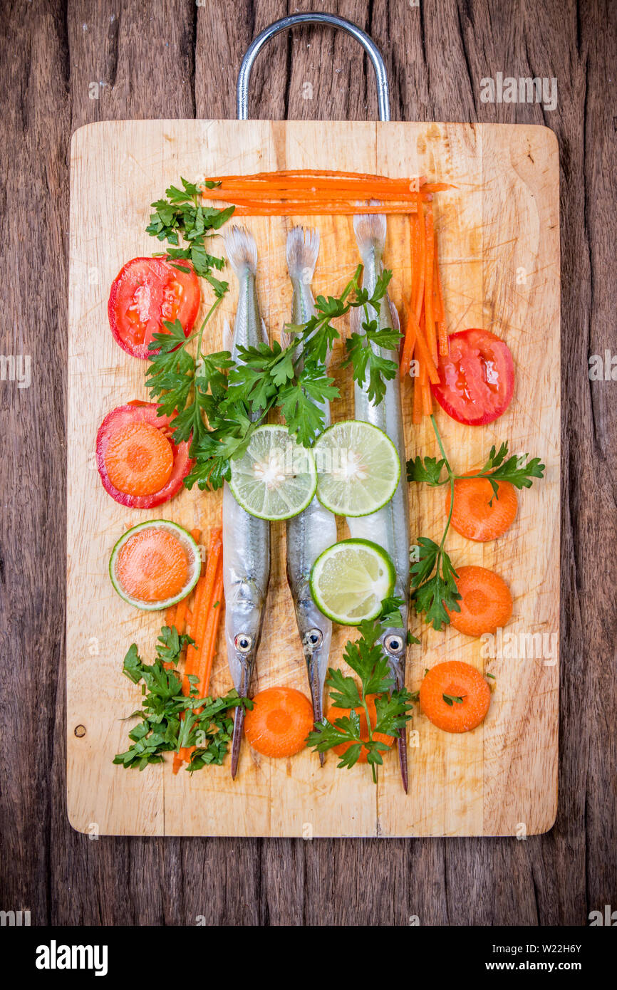 Fresh fish on wooden kitchen board Stock Photo - Alamy