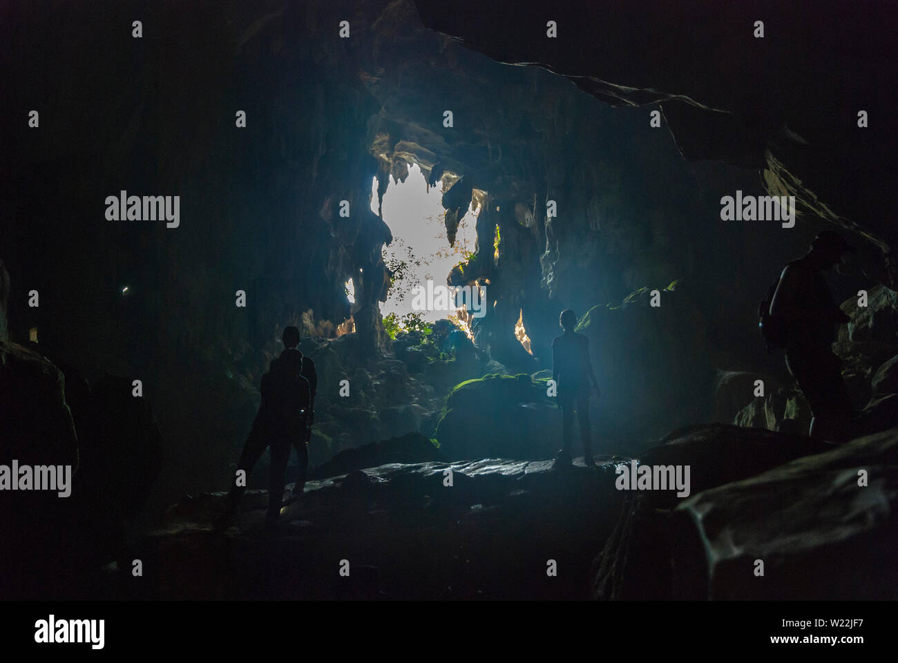 Silhouette of people exploring caves near Vang Vieng, Laos Stock Photo ...