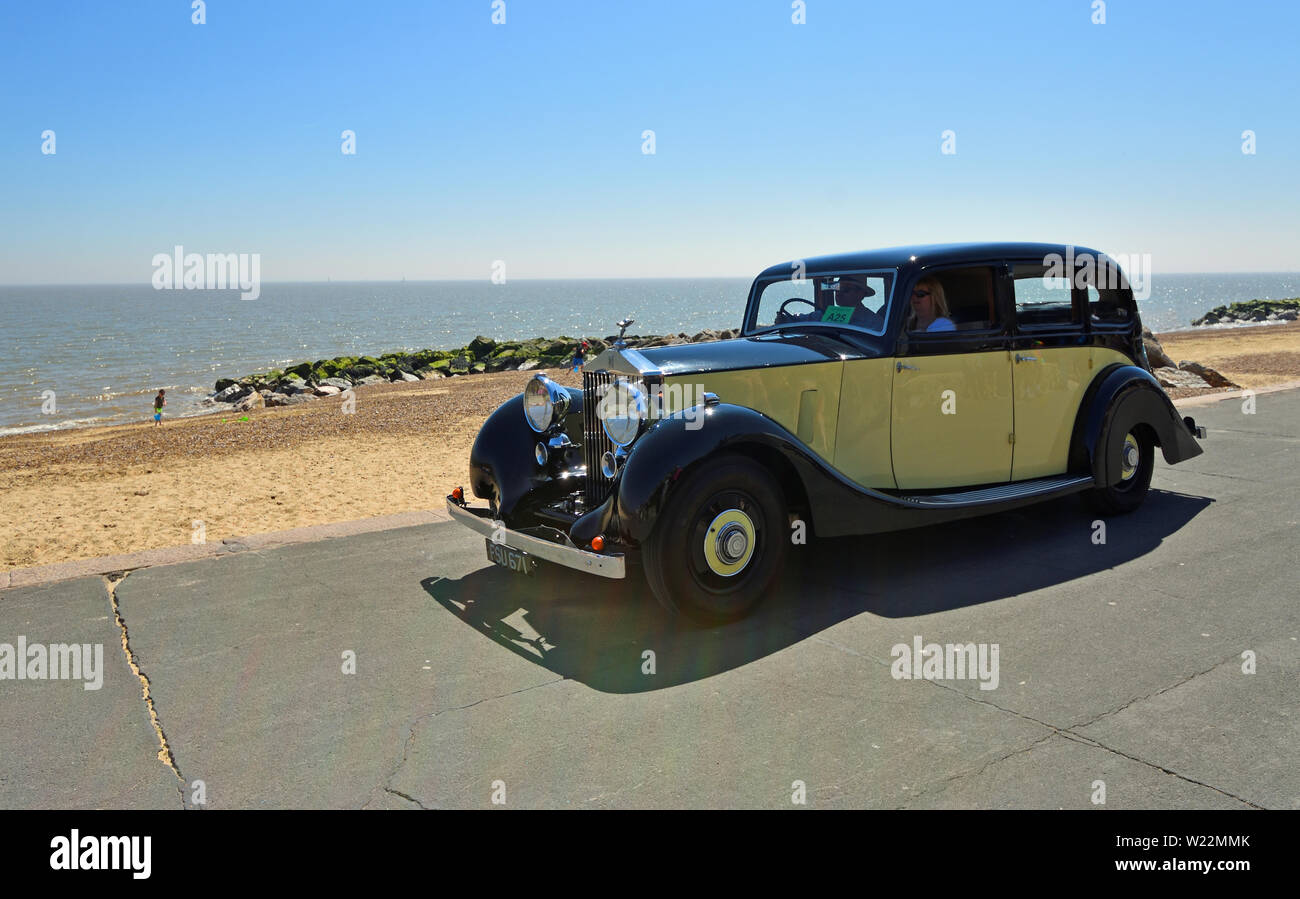 Vintage Cream and Black Rolls Royce Motor Car being driven along ...