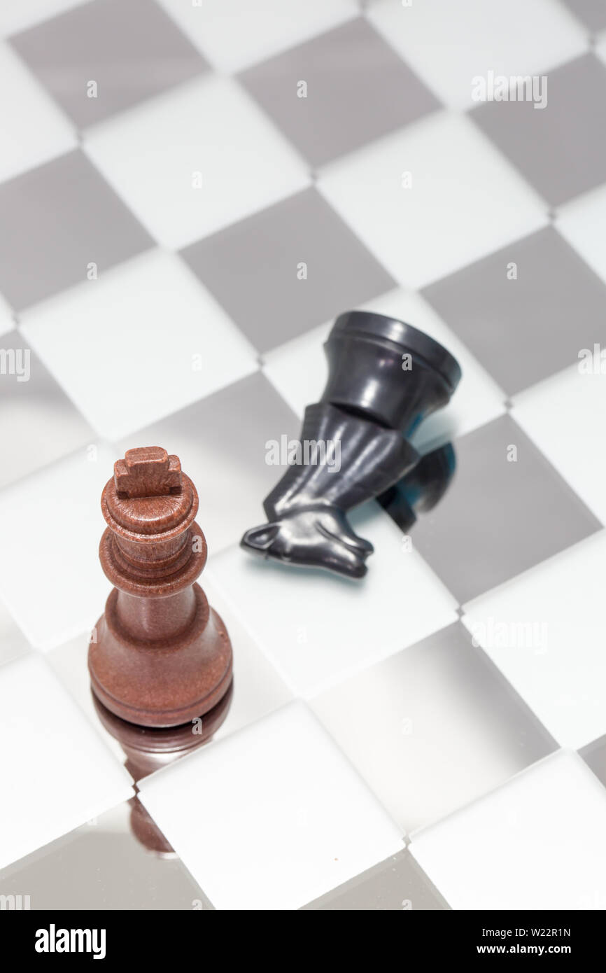 Two wooden chess pieces alone on a chess board Stock Photo - Alamy