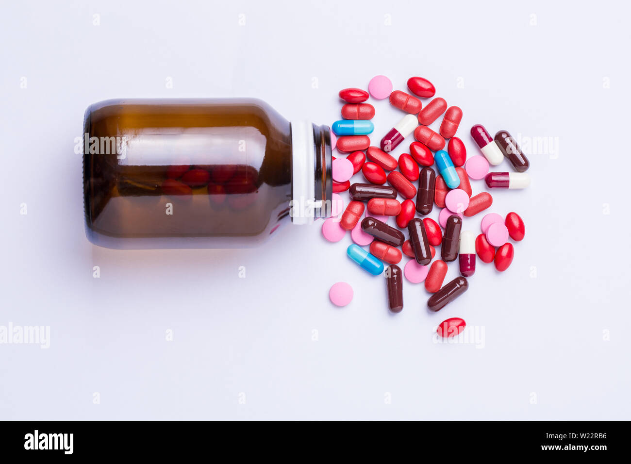 Pills pouring out of the brown bottle,top view Stock Photo - Alamy