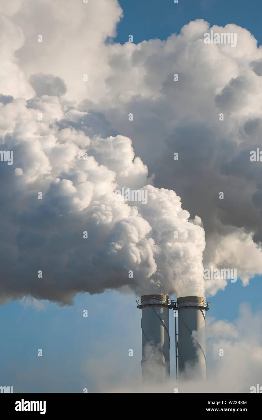 Thick smoke emitted from factory chimneys Stock Photo - Alamy
