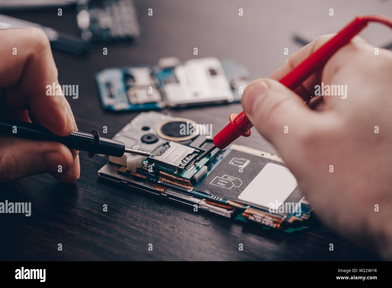 mobile phone repair, hands closeup on a wooden table Stock Photo - Alamy