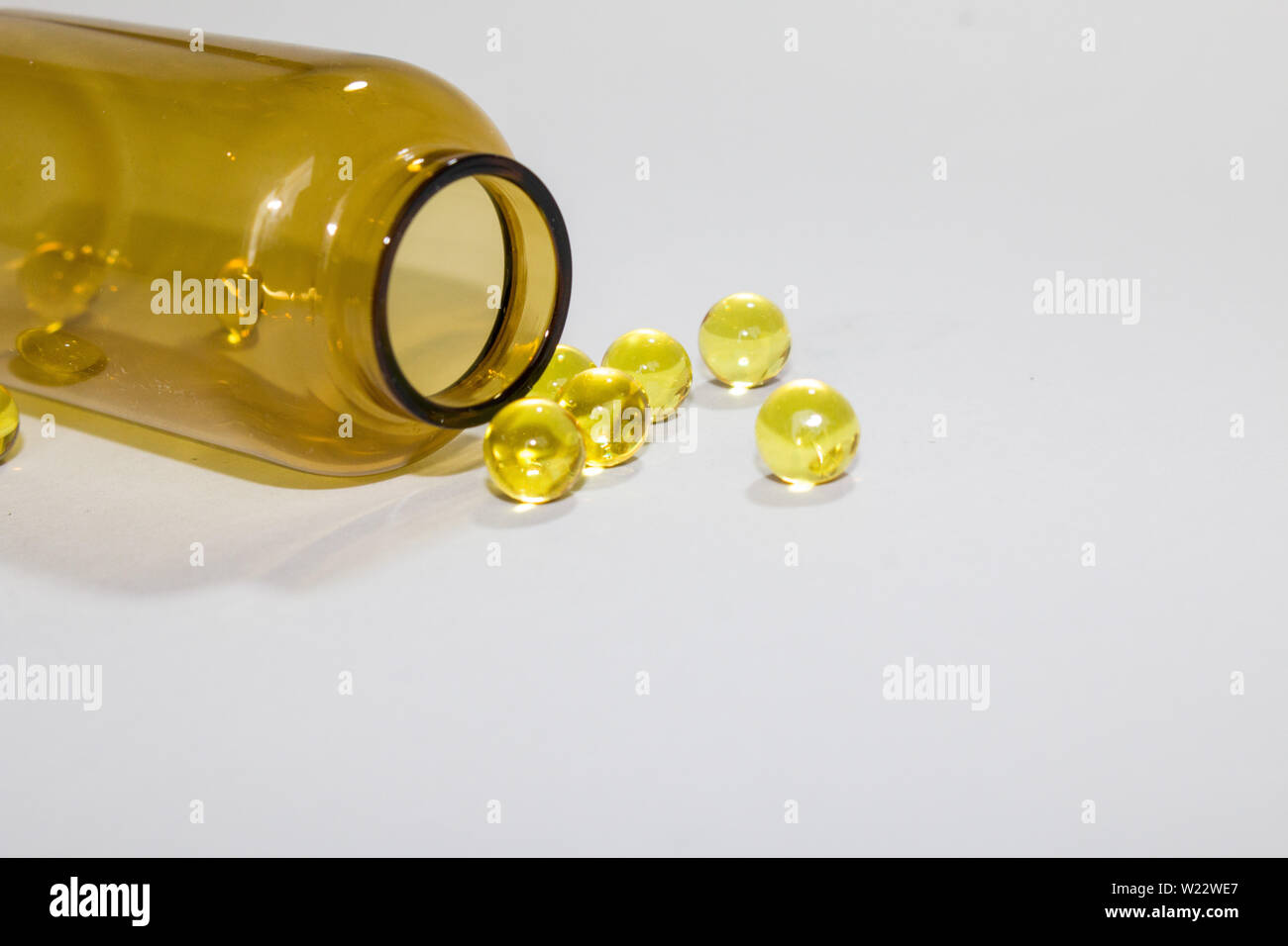 yellow transparent round tablets in a transparent bottle Stock Photo ...