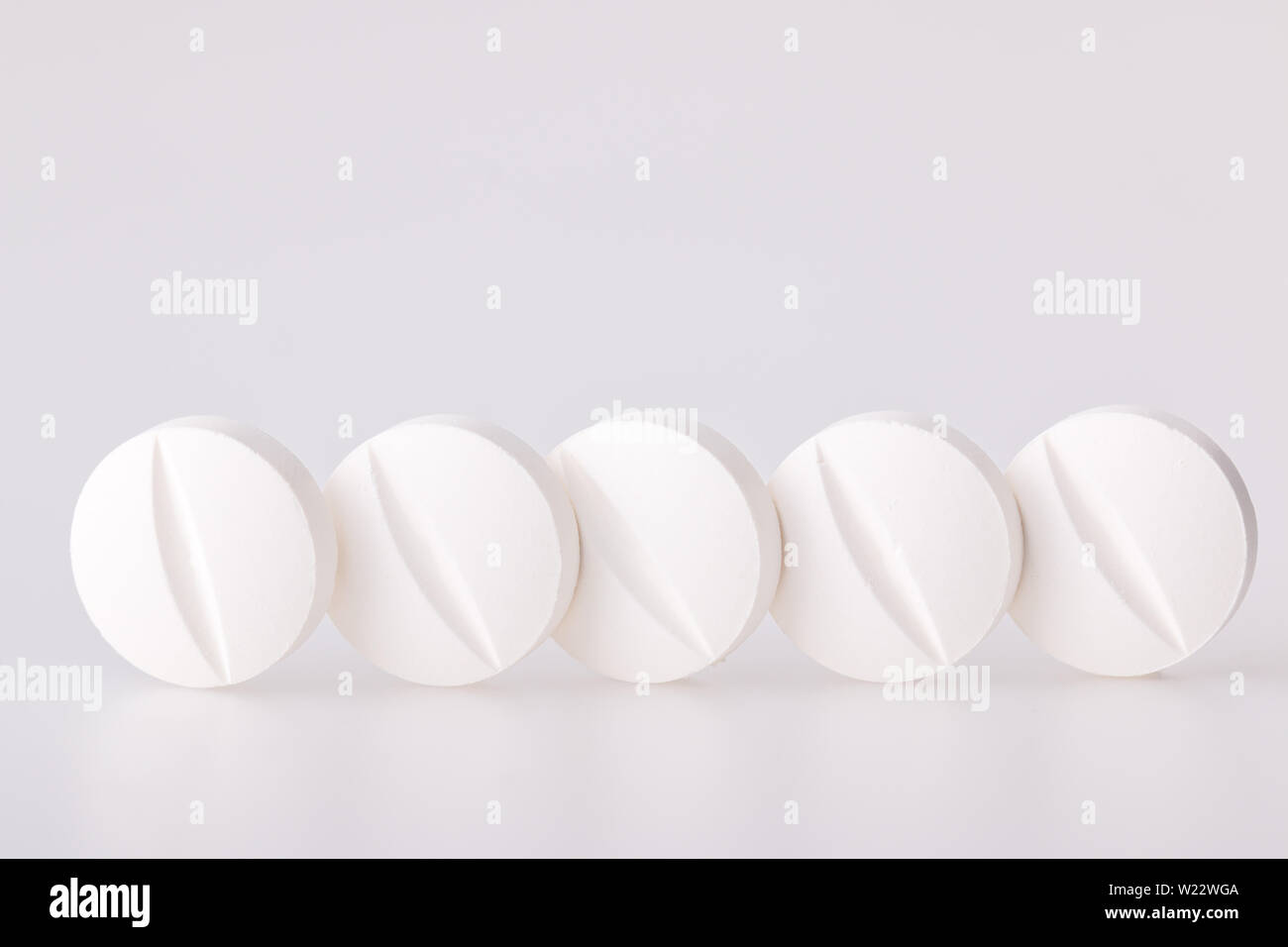 drug white tablet on white background Stock Photo - Alamy
