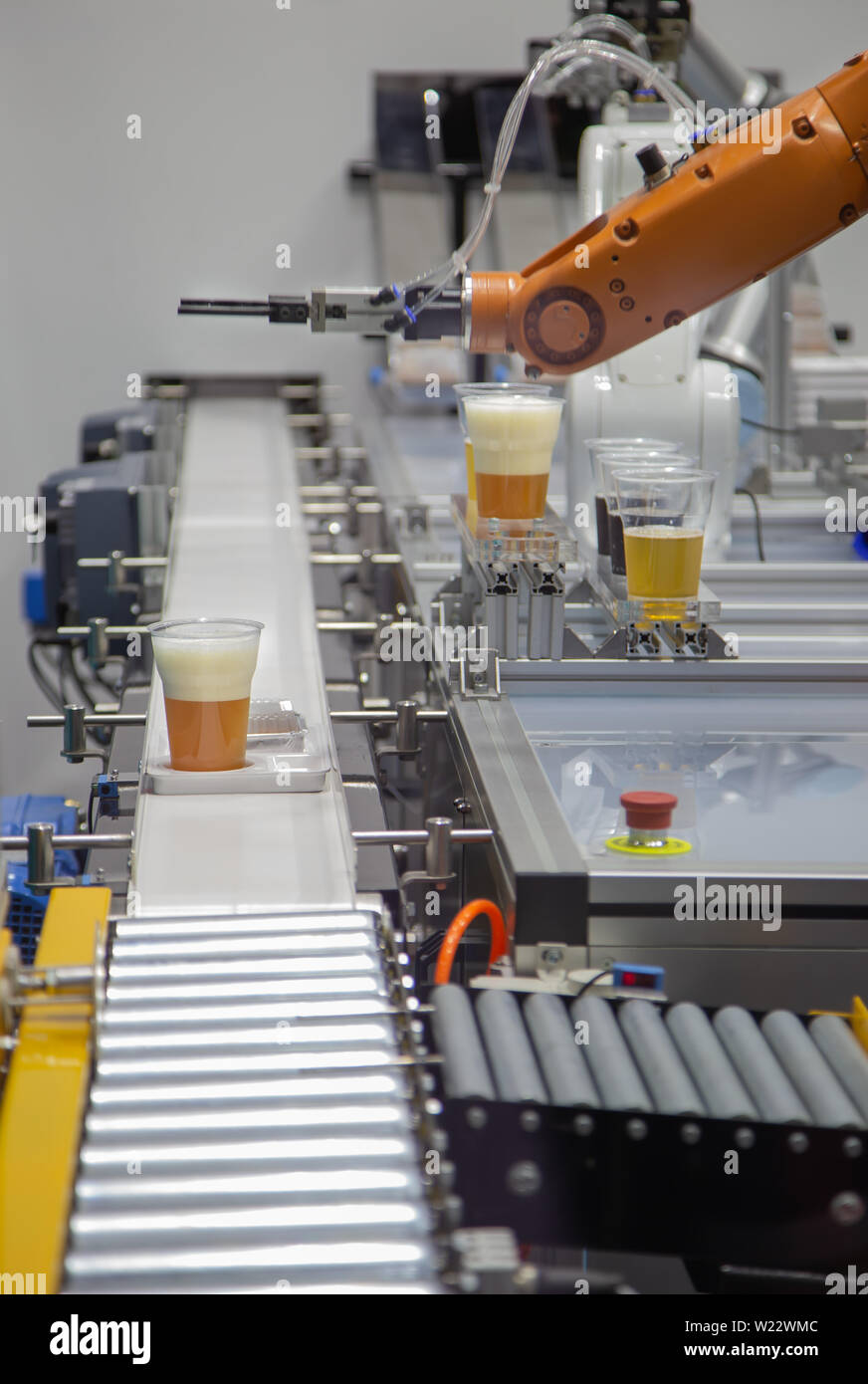 Robotic arm pouring and serving a glass of beer to conveyor belt Stock ...