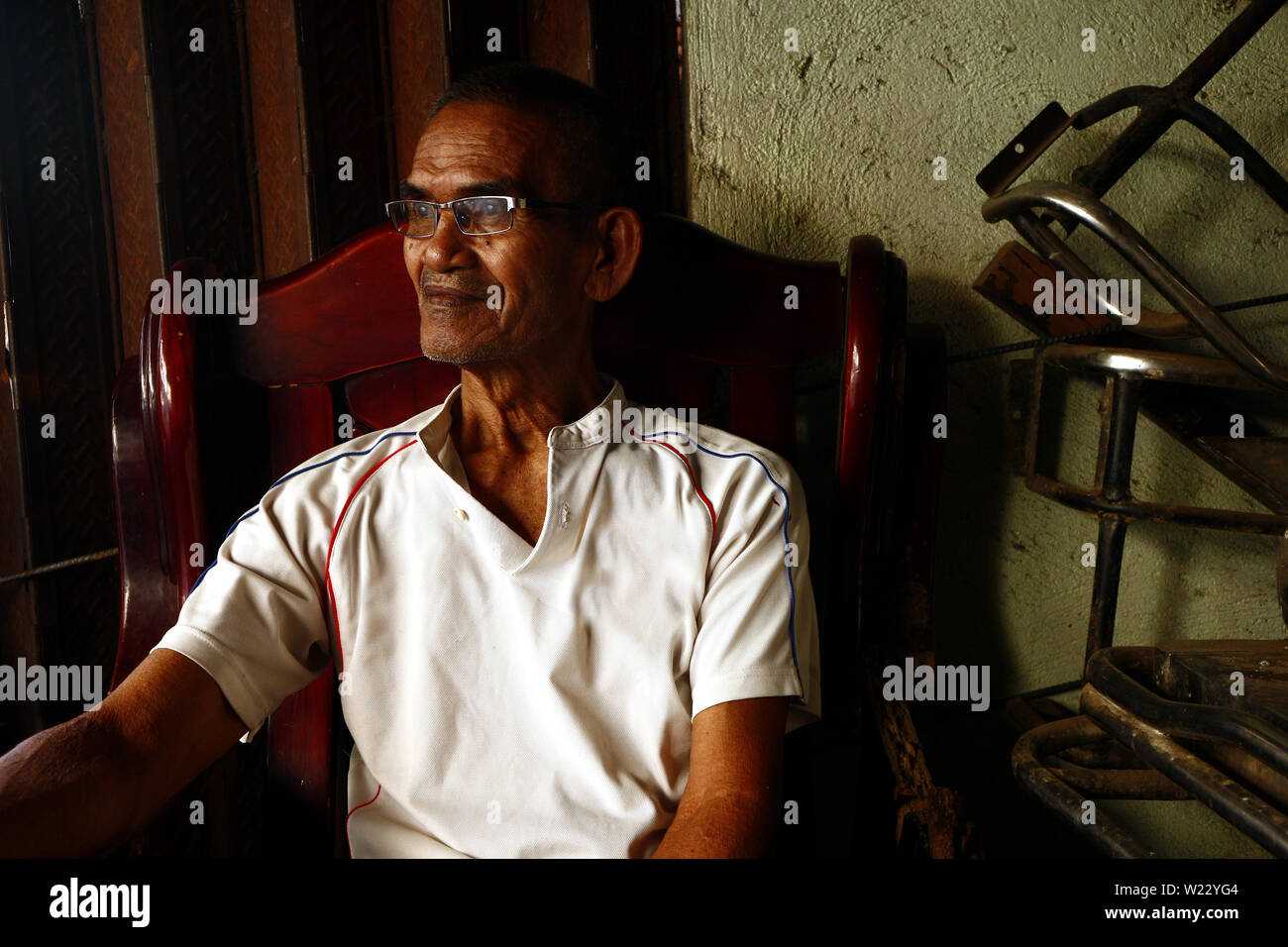 ANTIPOLO CITY, PHILIPPINES – JULY 3, 2019: A mature Filipino man sits ...