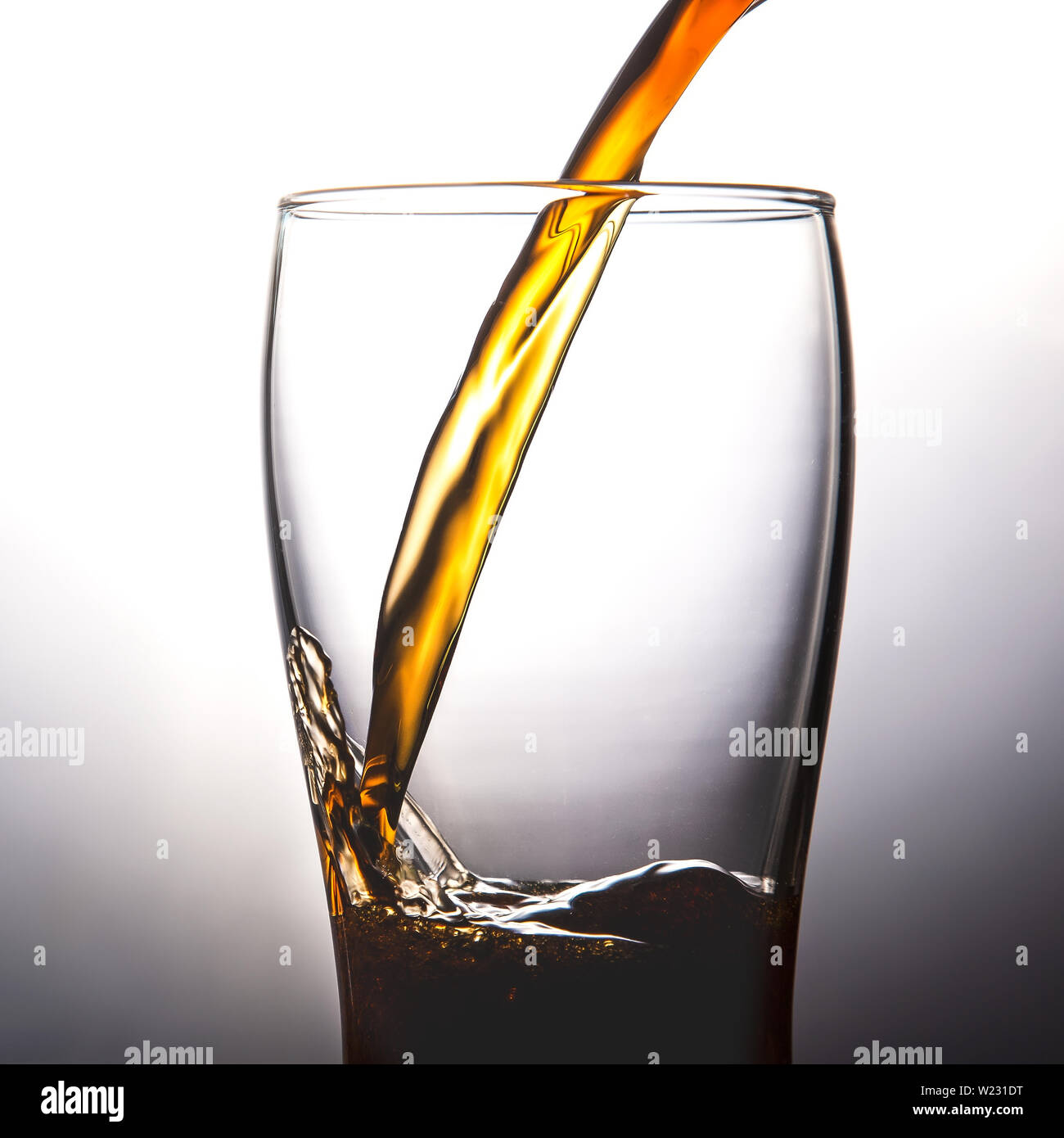 pouring cola into glass with ice on white background Copy space Place ...