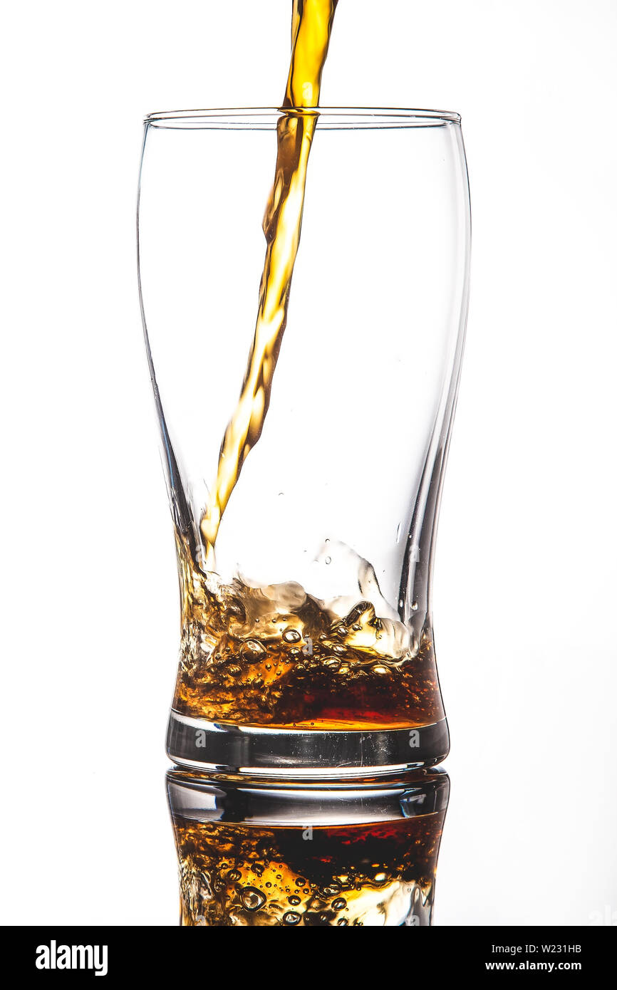 pouring cola into glass with ice on white background Copy space Place ...