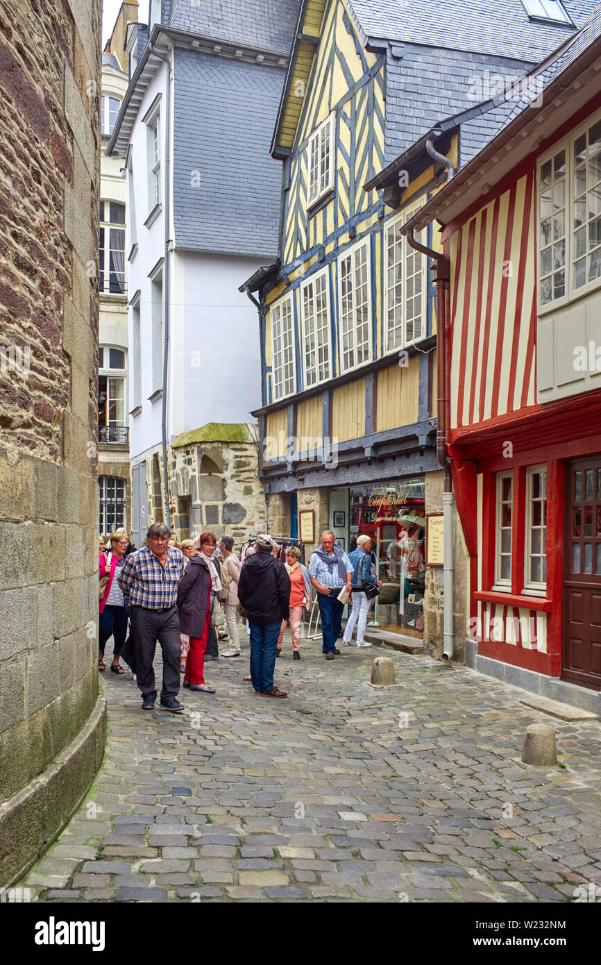 Tourists walking in the old streets of Rennes the capital of Brittany ...