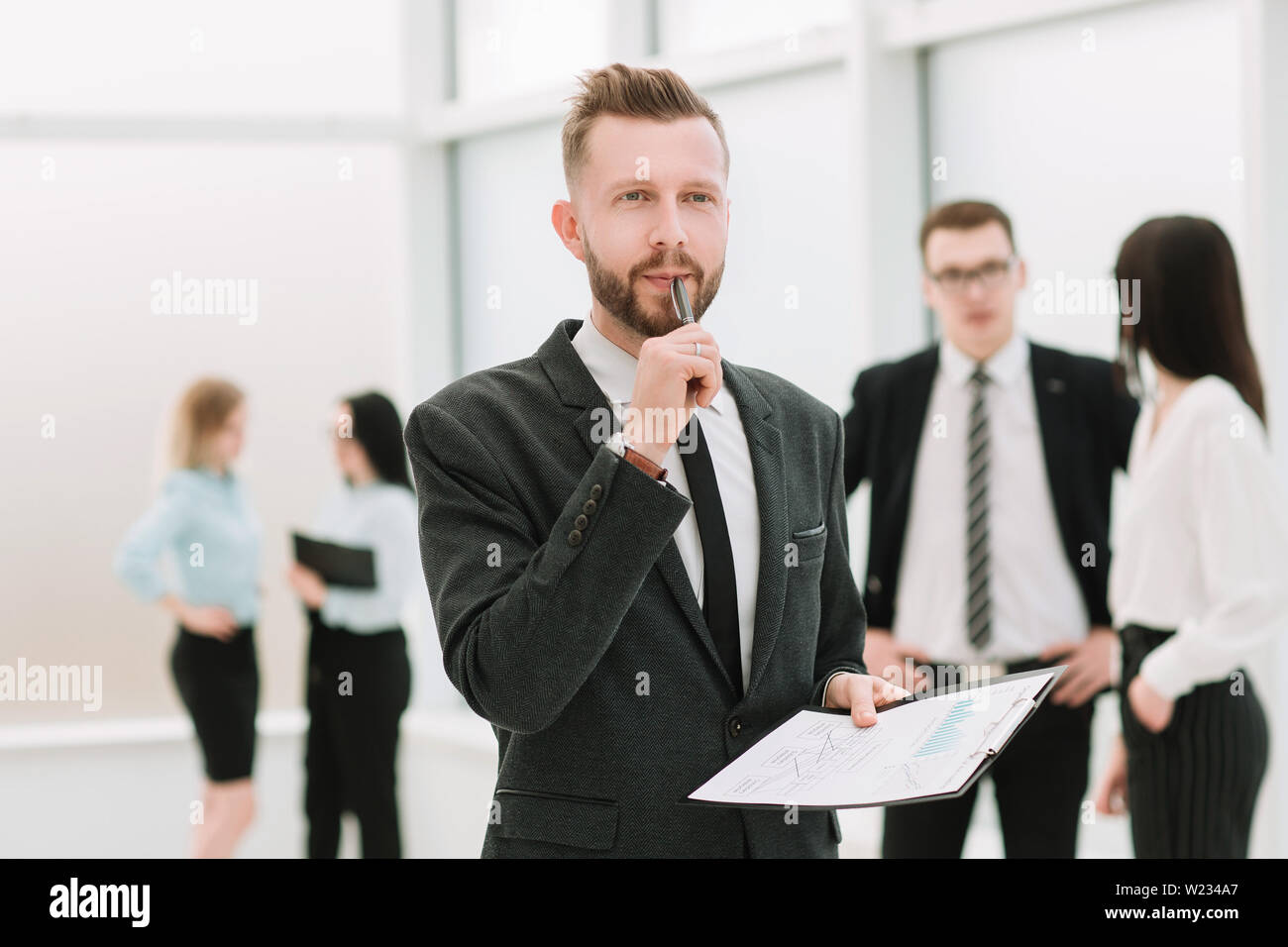 serious businessman considering the terms of the contract . photo with ...