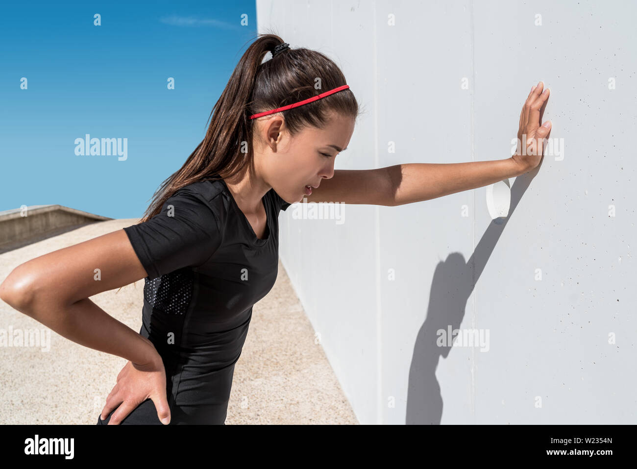 Tired athlete runner exhausted of cardio workout breathing hard after ...