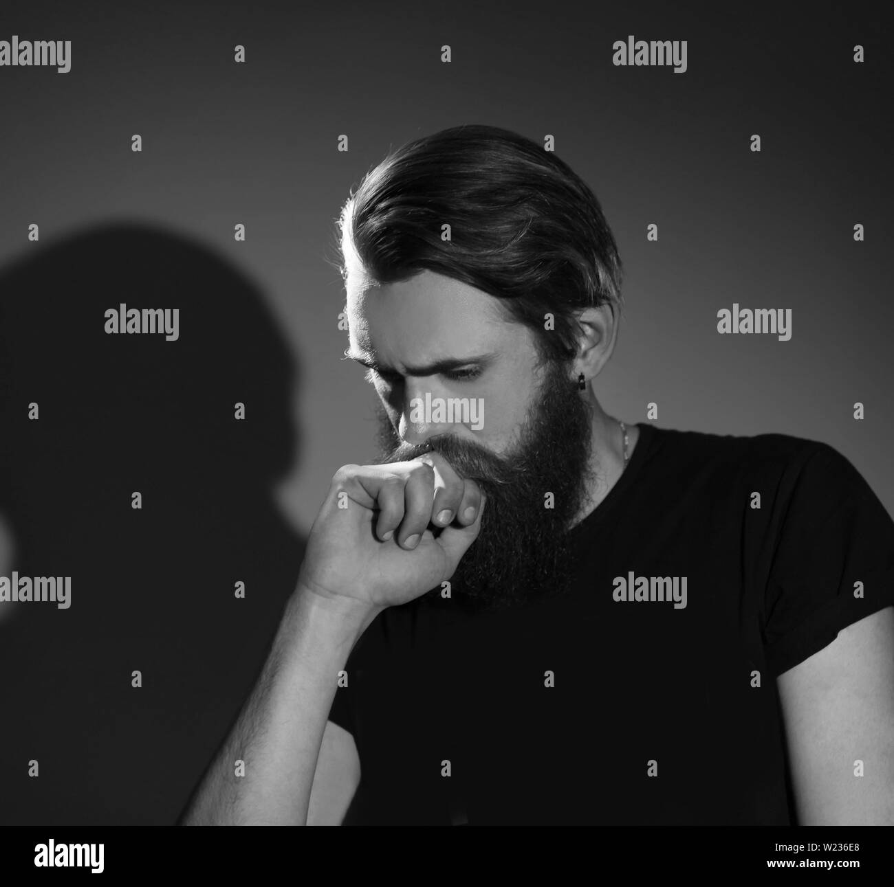 Bearded young man sitting Black and White Stock Photos & Images - Alamy