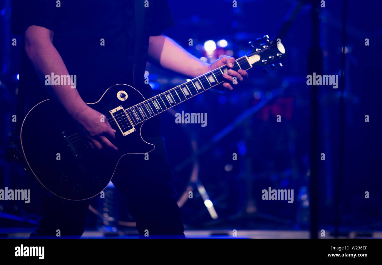 Close up scene of electric guitar player on performing stage during ...