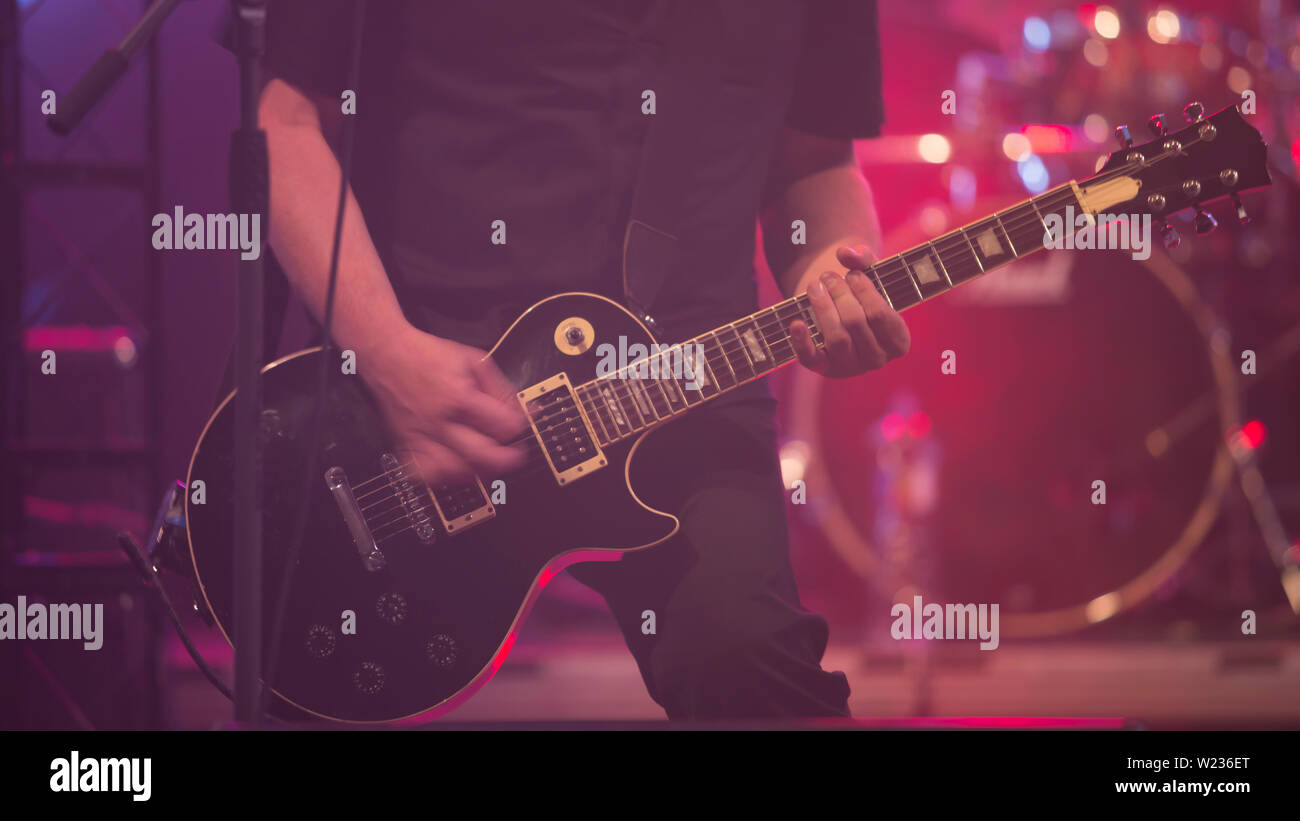 Close up scene of electric guitar player on performing stage during ...