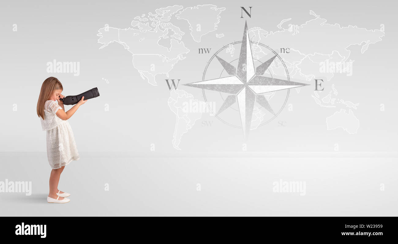 Little girl looking through spyglass to map and compass concept Stock ...
