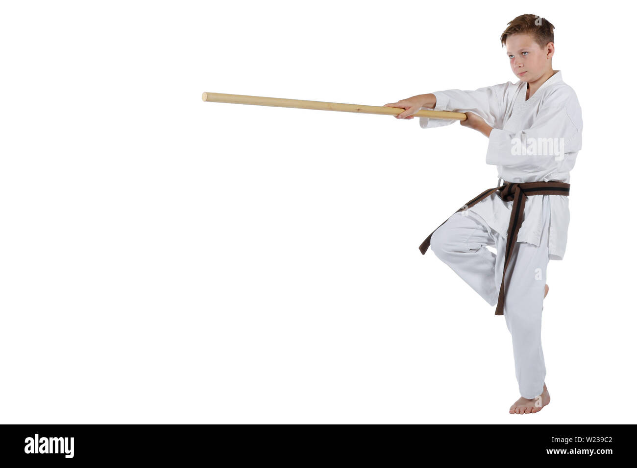 Teenage caucasian boy wearing a karate uniform using a bo Stock Photo ...