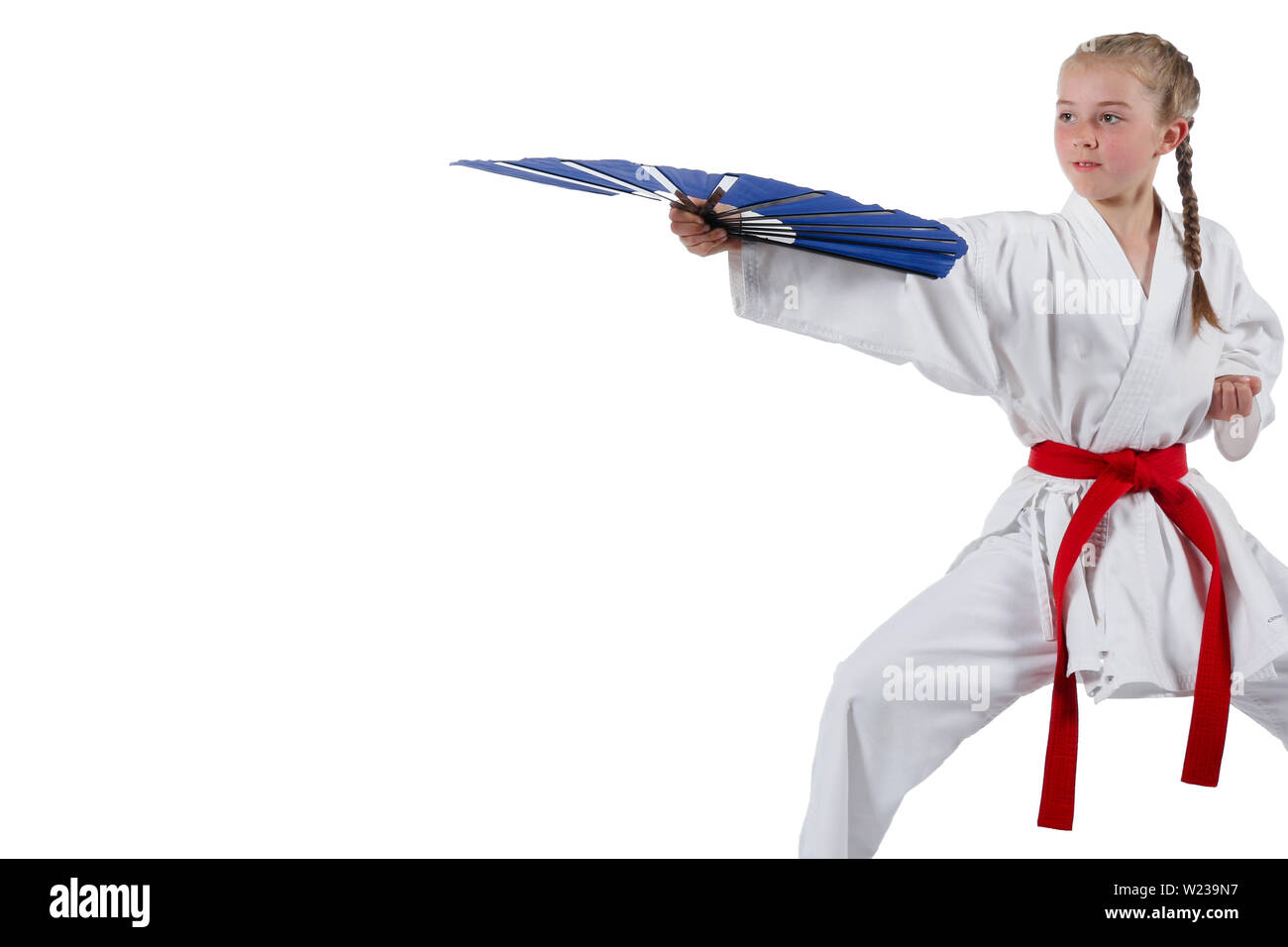 Pre-teen caucasian girl wearing a karate uniform with a fan Stock Photo ...