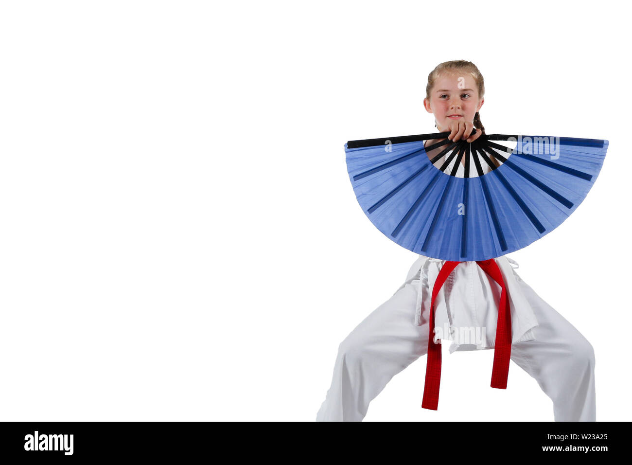 Pre-teen caucasian girl wearing a karate uniform with a fan Stock Photo ...