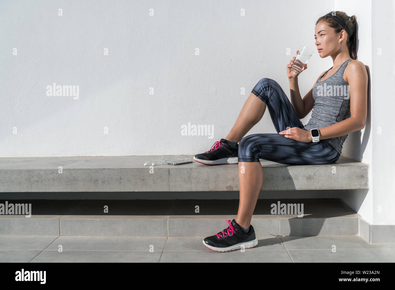 Fitness athlete woman drinking water during cardio workout break ...