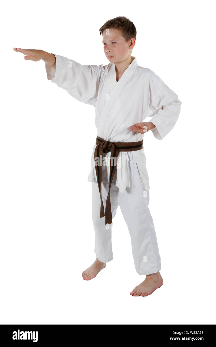 Teenage caucasian boy wearing a karate uniform doing a Haito strike ...