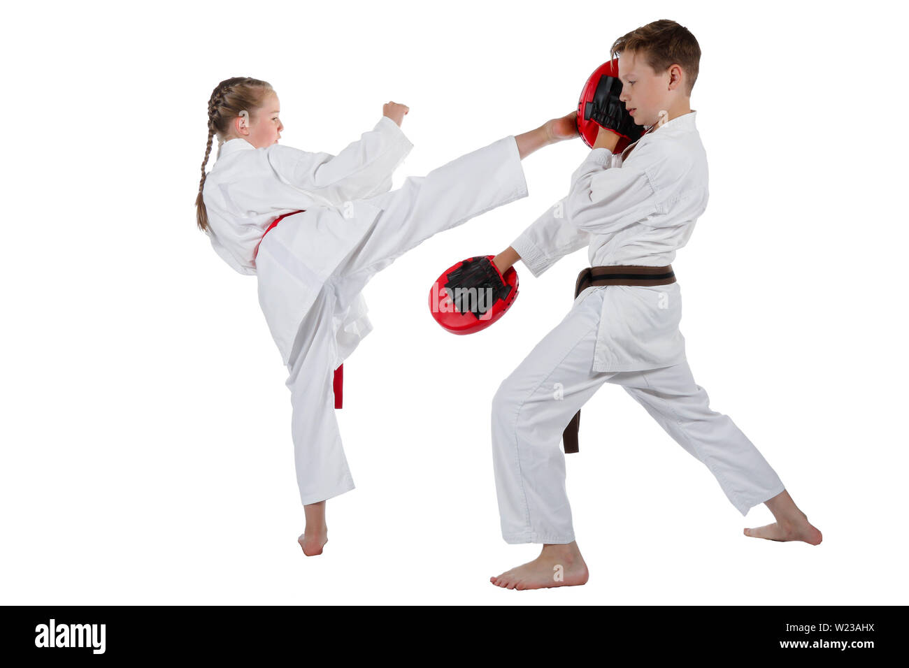 Caucasian pre-teen girl and teenage boy doing karate Stock Photo - Alamy