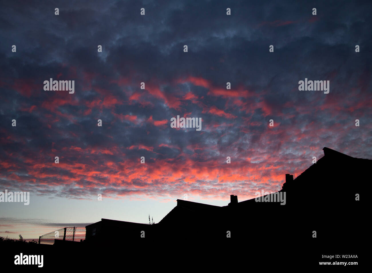 Sunset over rooftops Stock Photo - Alamy