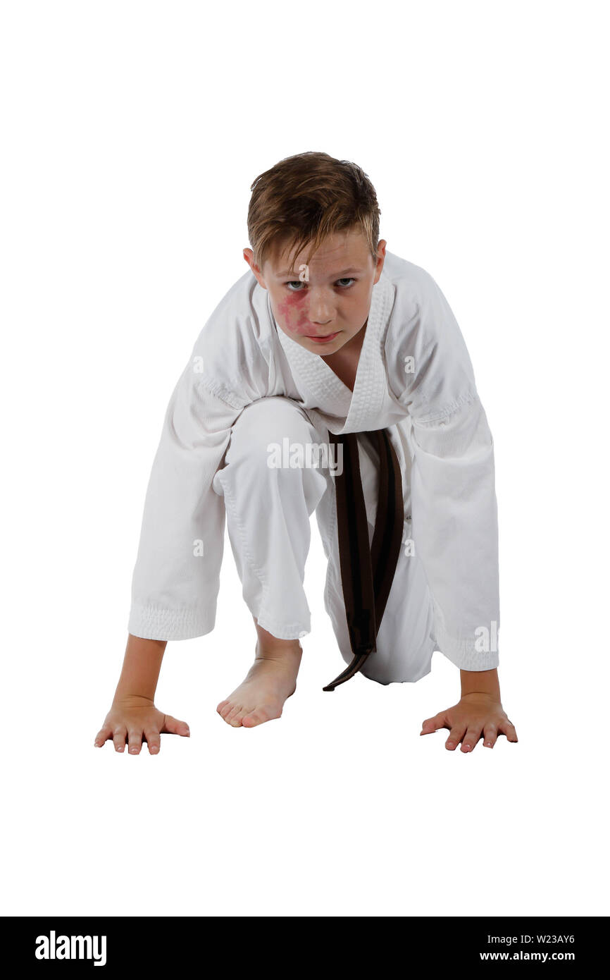 Teenage caucasian boy wearing a karate uniform doing karate Stock Photo ...