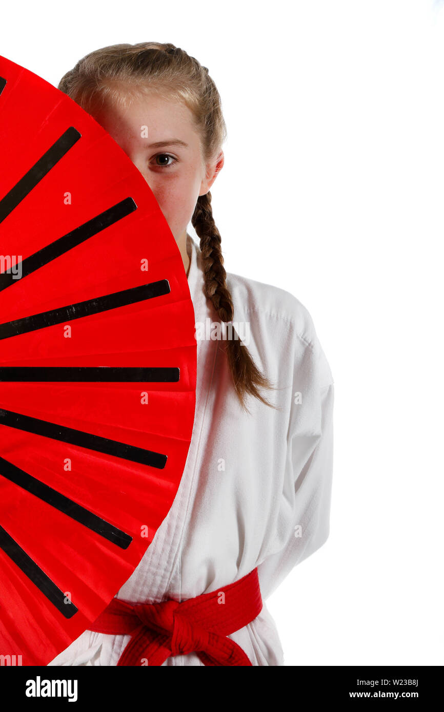 Pre-teen caucasian girl wearing a karate uniform with a fan Stock Photo ...