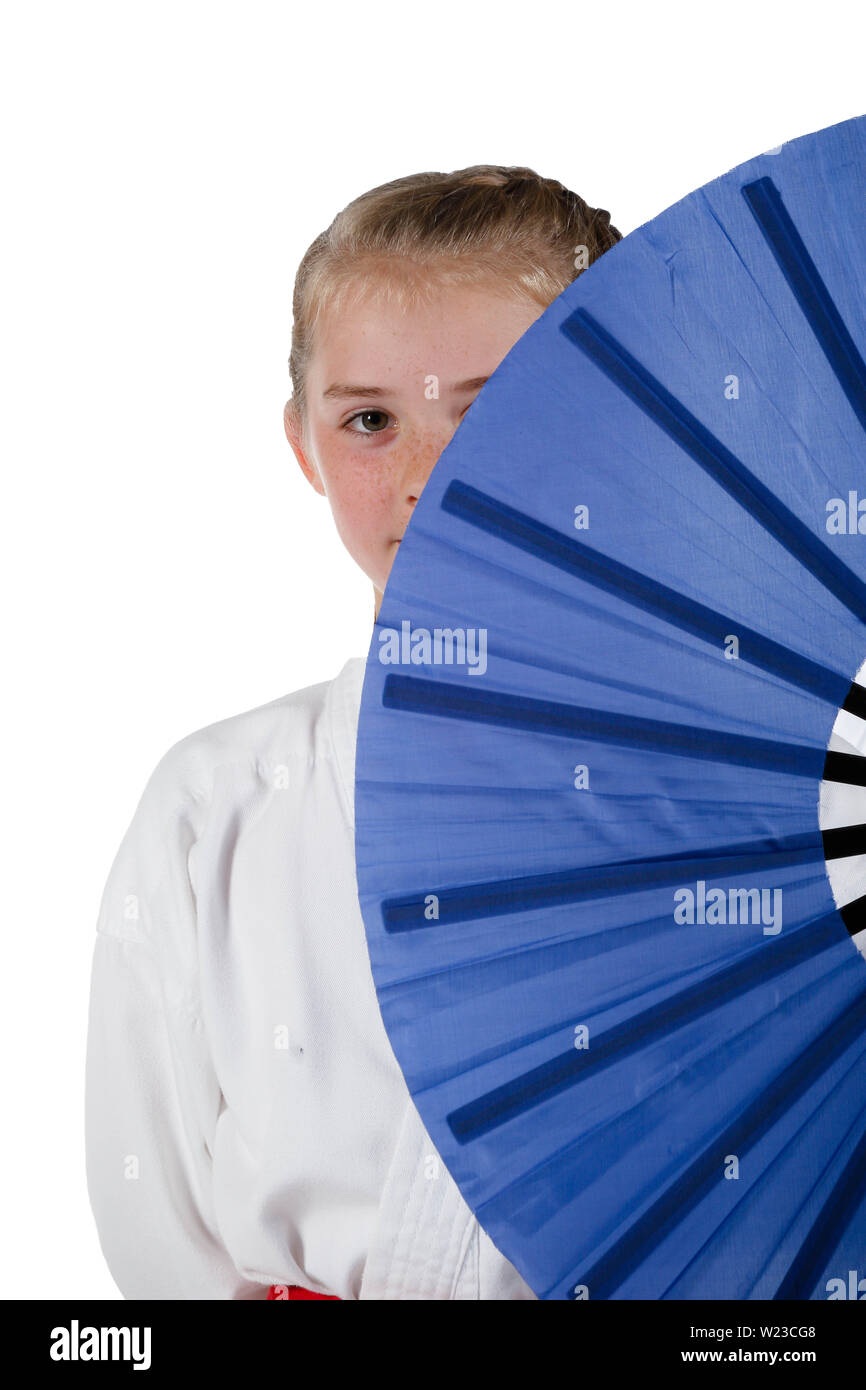 Pre-teen caucasian girl wearing a karate uniform with a fan Stock Photo ...