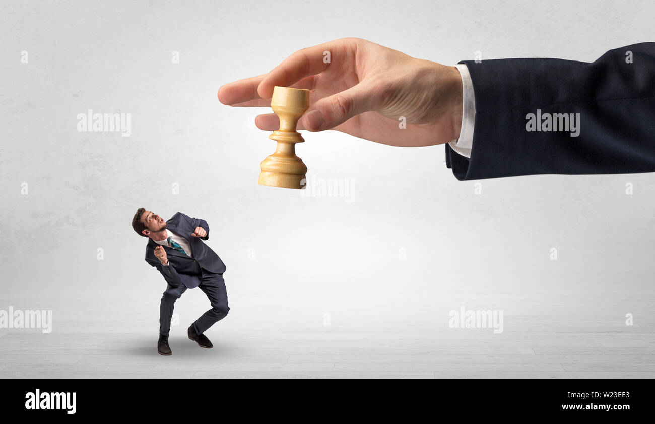 Big hand holding chessman and down little afraid businessman concept in ...