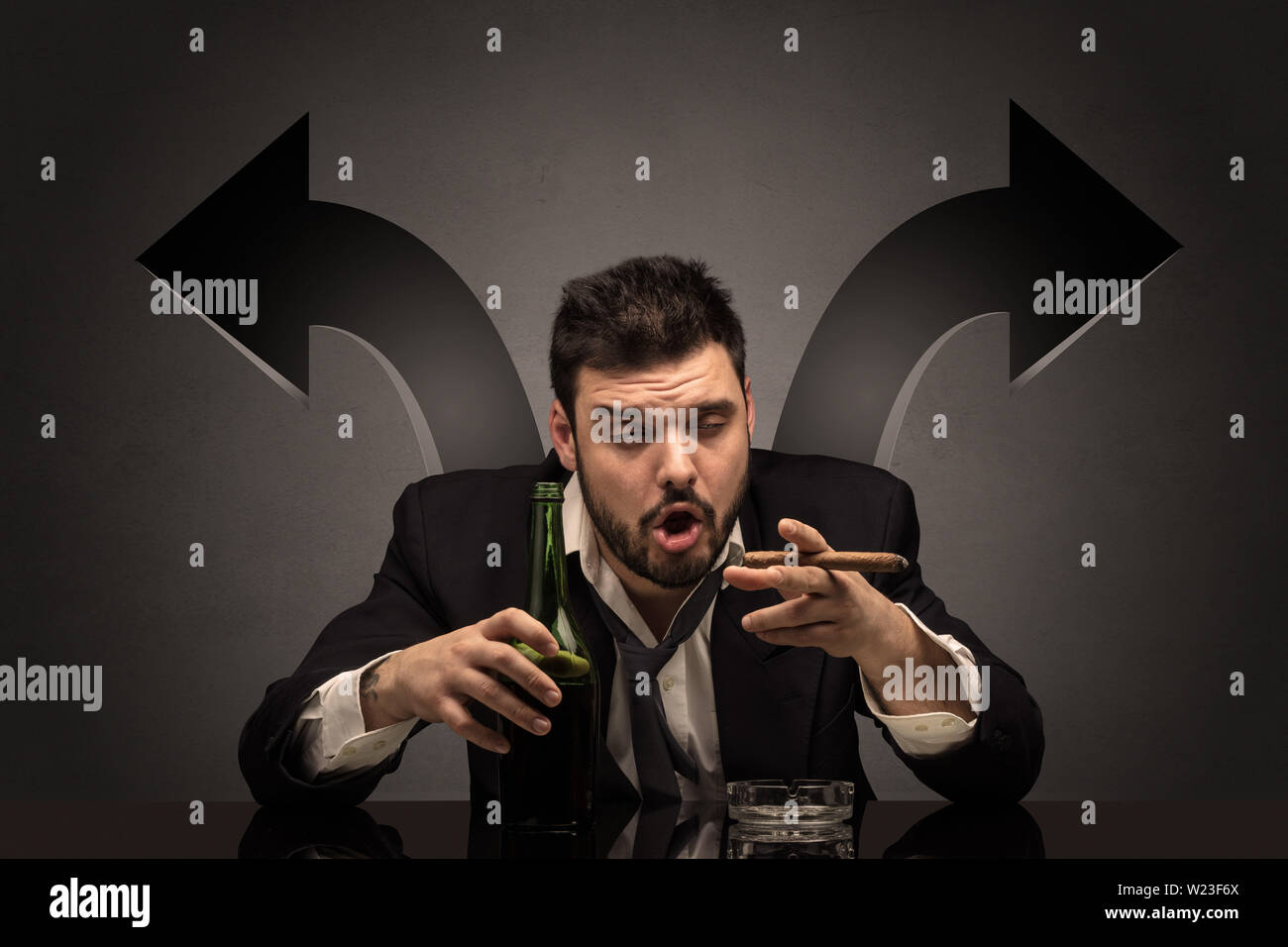 Drunk disappointed man sitting at table with arrows around Stock Photo ...