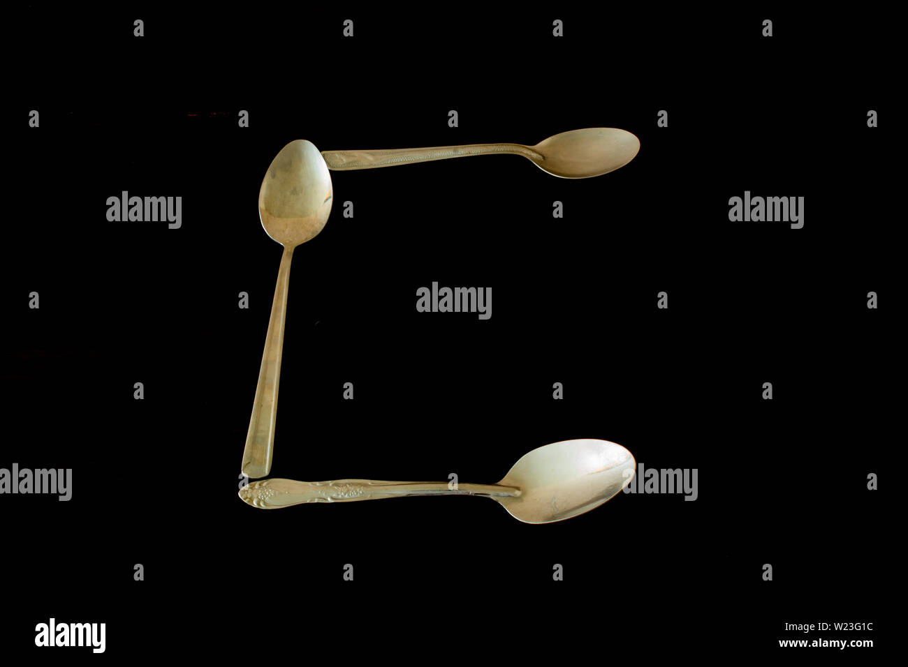Letter "C" made of spoons Stock Photo - Alamy