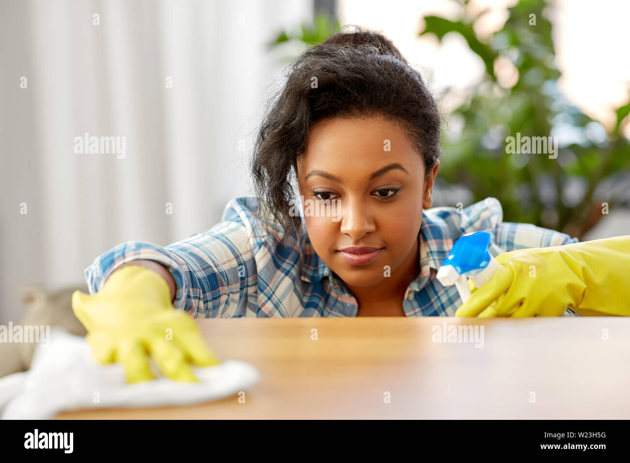 african american woman cleaning table at home Stock Photo - Alamy
