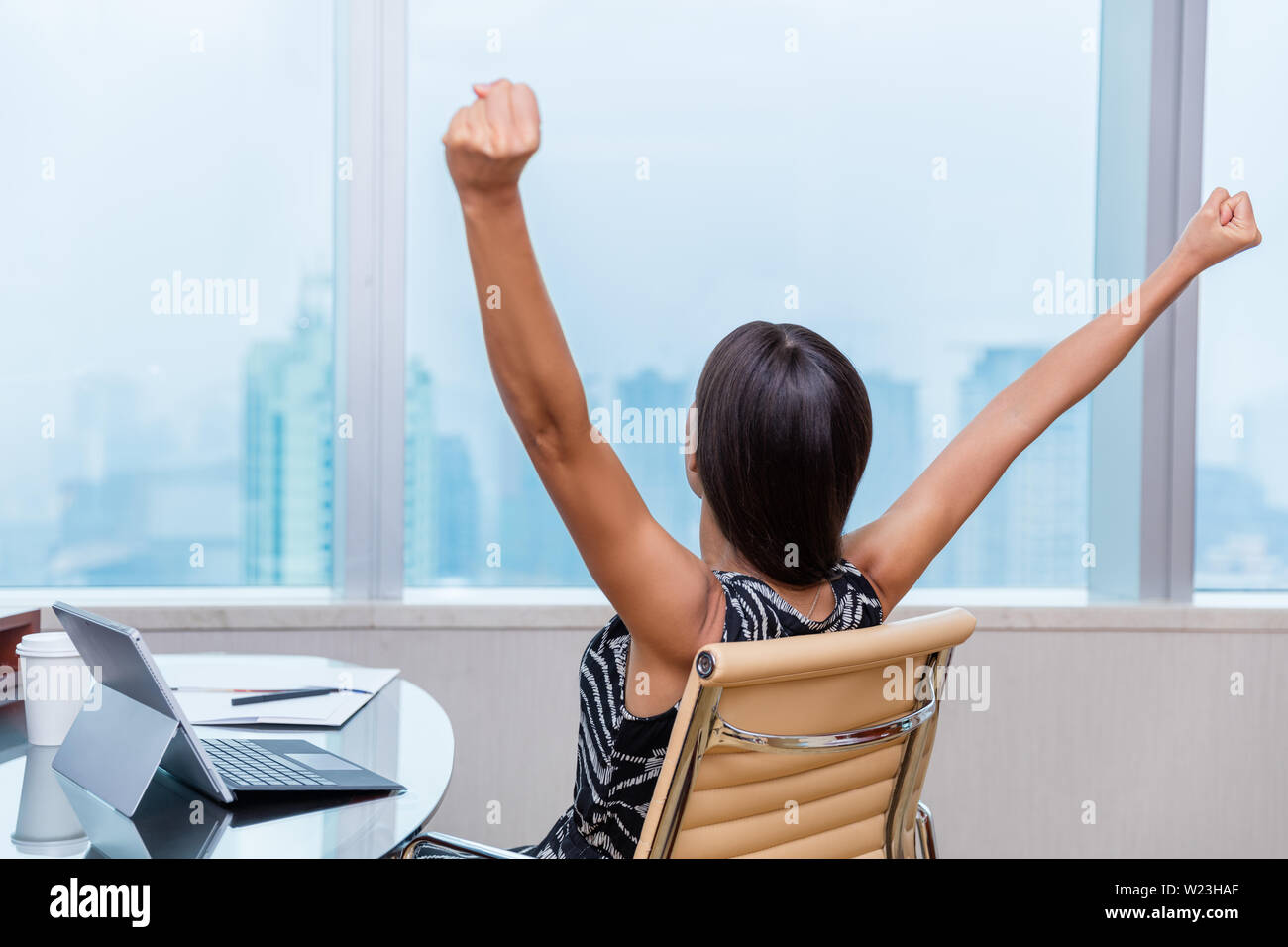 Winning office worker working woman with arms raised up outstretched in ...