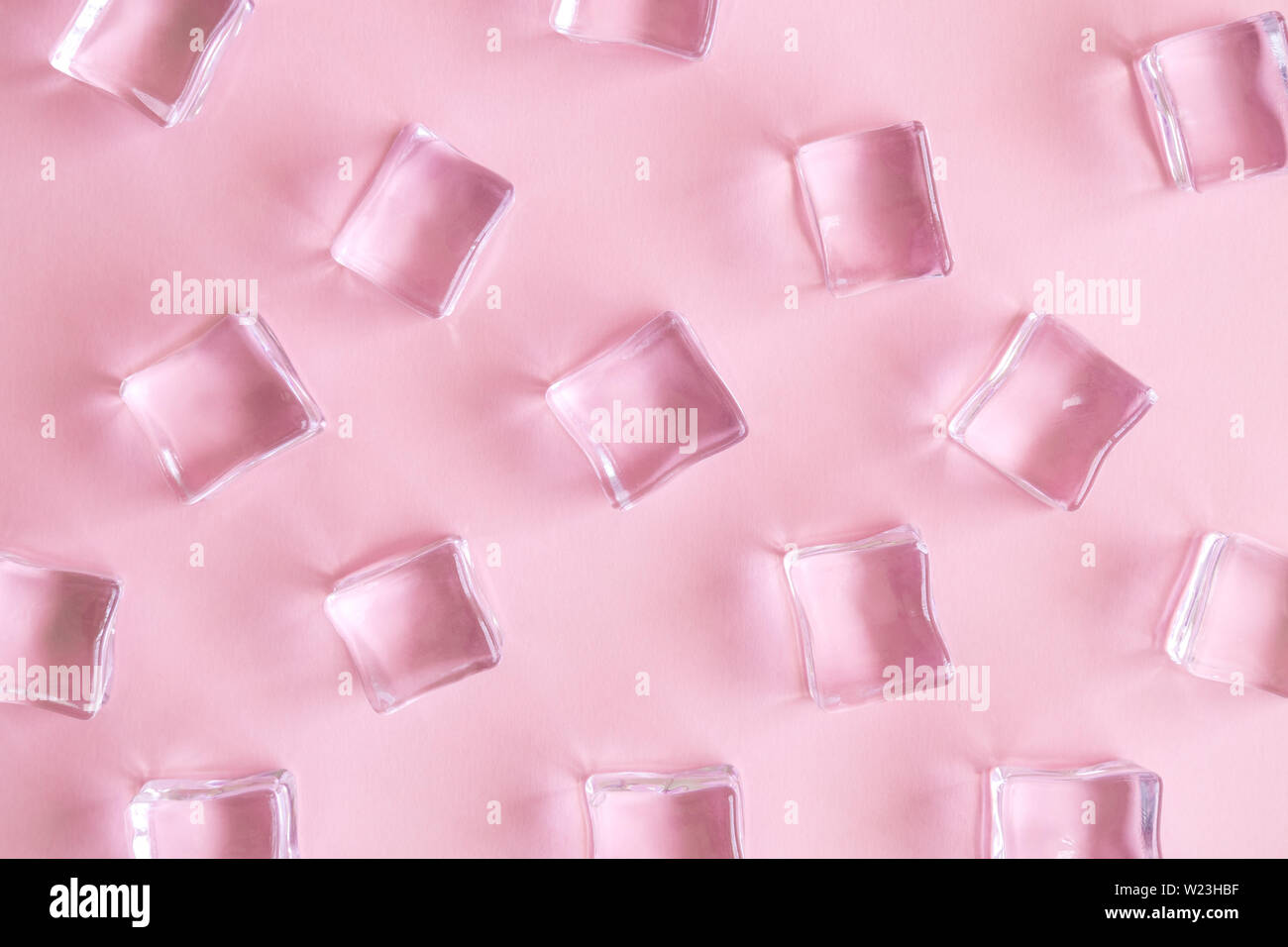 Flat lay of ice cubes on bright pink background minimal drink and ...