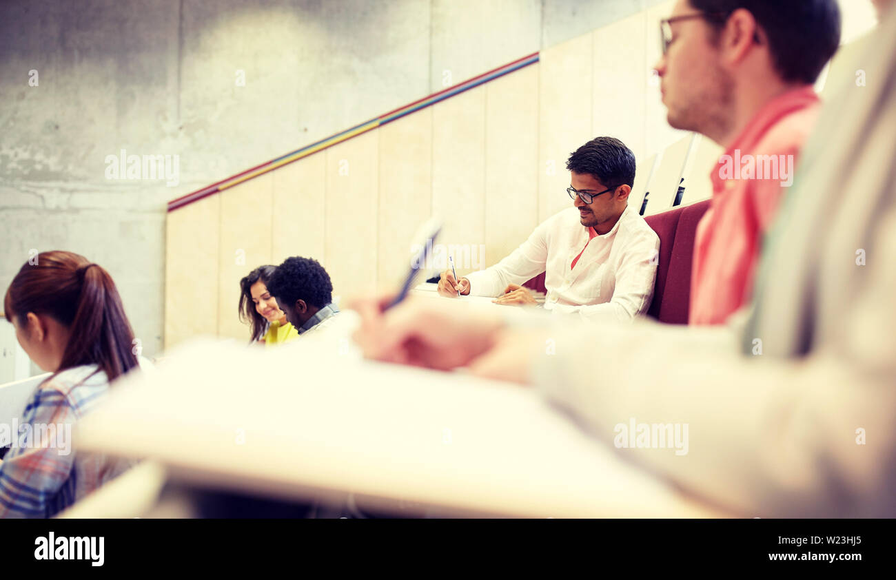 group of students with notebooks in lecture hall Stock Photo - Alamy