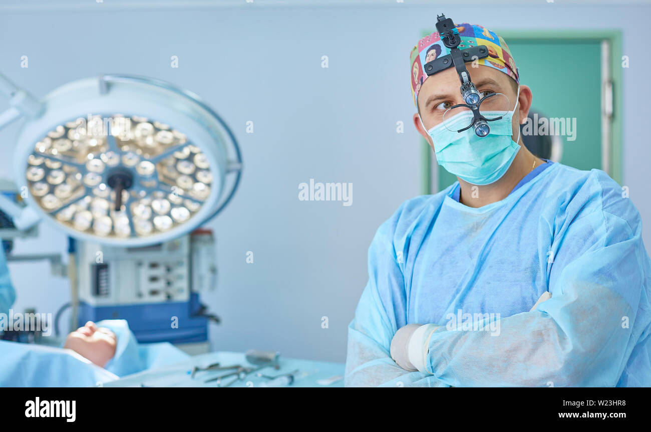 Several doctors surrounding patient on operation table during their ...