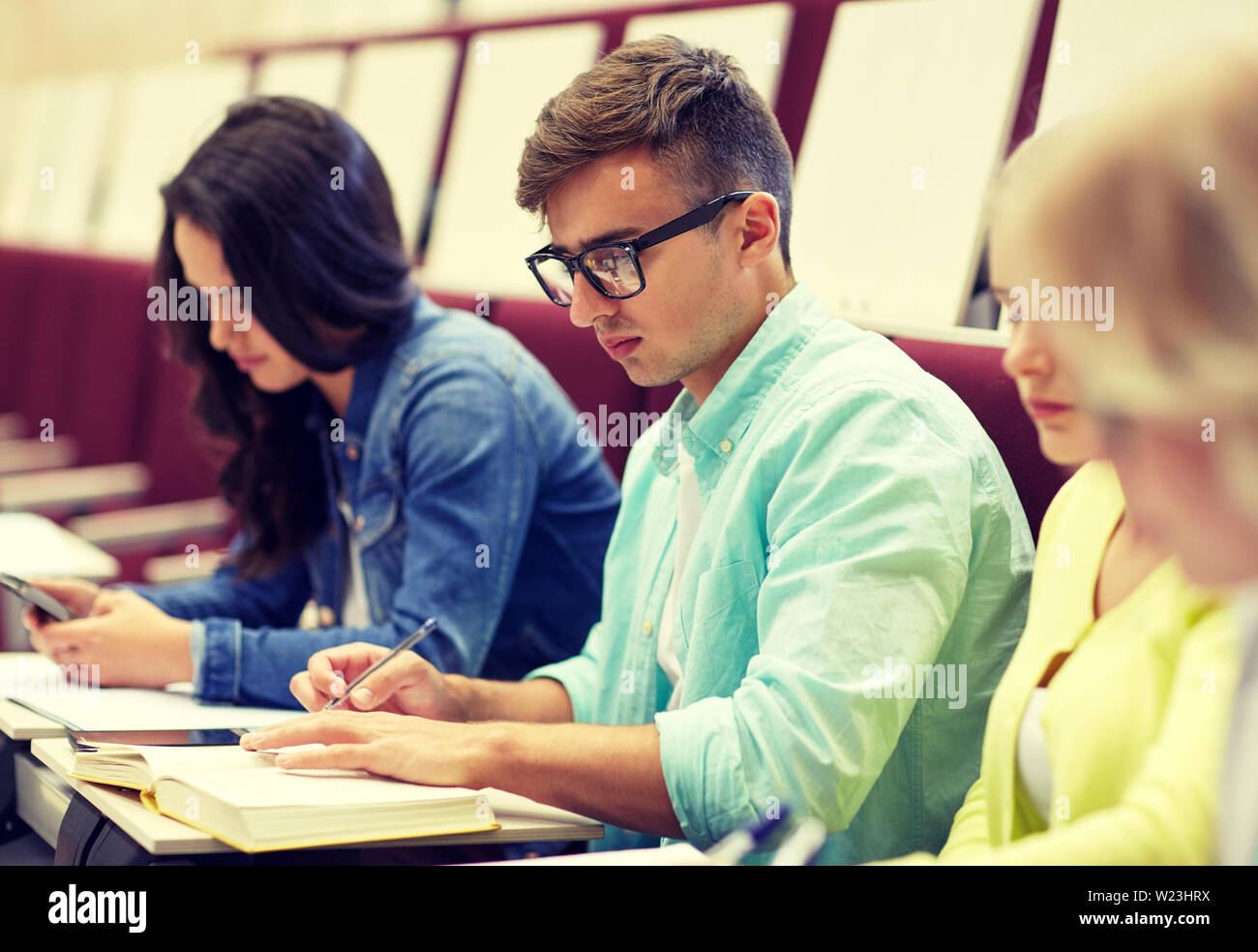 group of students with books writing at lecture Stock Photo - Alamy