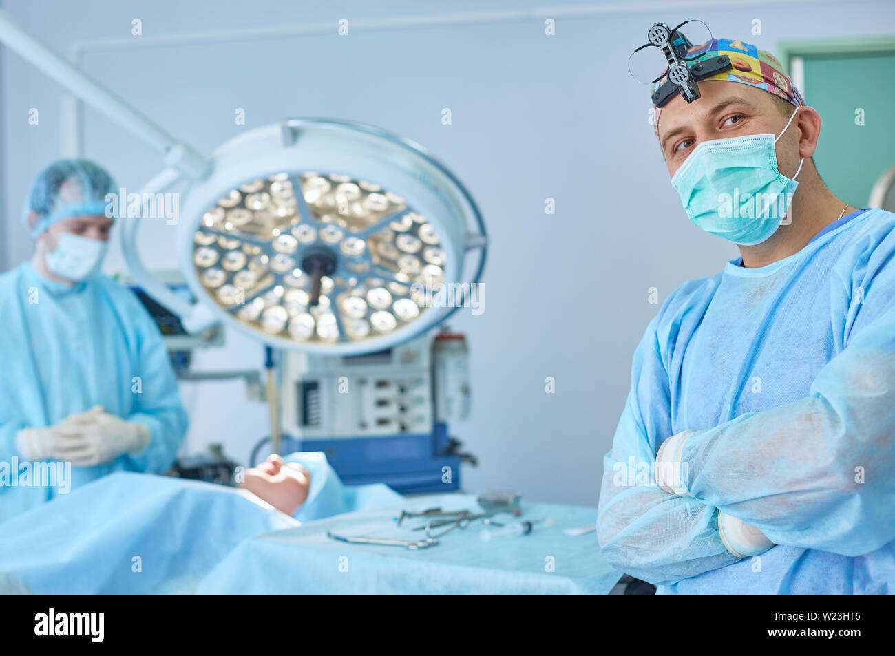 Several doctors surrounding patient on operation table during their ...